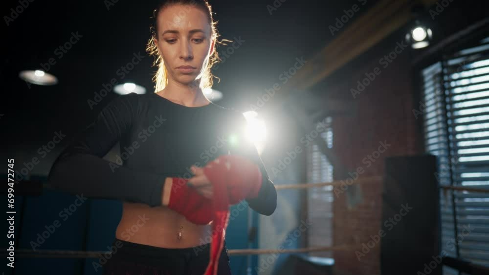 Woman fighter boxer wraps her hand with boxing bandage. Kickboxing ...