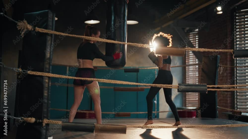 Women coach sport trainer and young curly sportswoman in boxing gloves boxing training for self ...