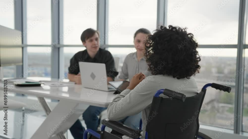 African american girl in wheelchair on job interview in modern office ...