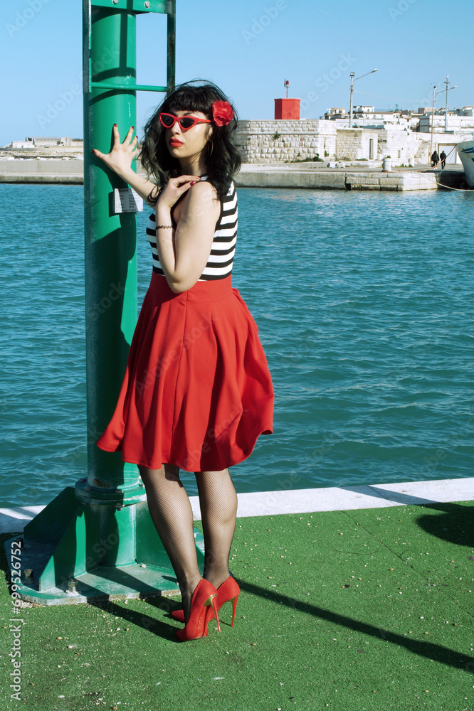 Port harbor pin-up: Red skirt, stripes, retro glasses. Red heels ...