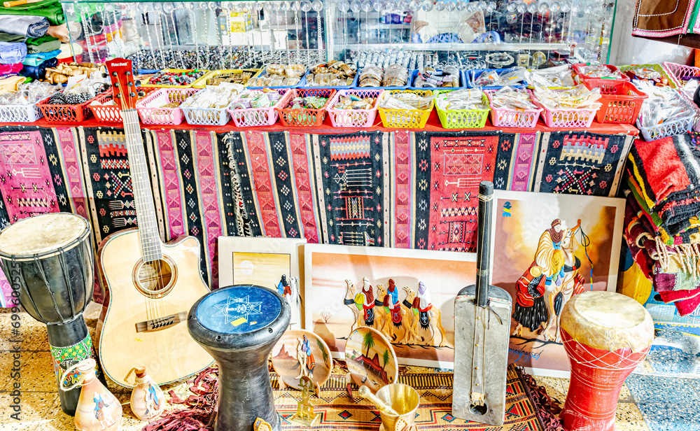 A counter of a craft and souvenir store. With musical instruments, a ...
