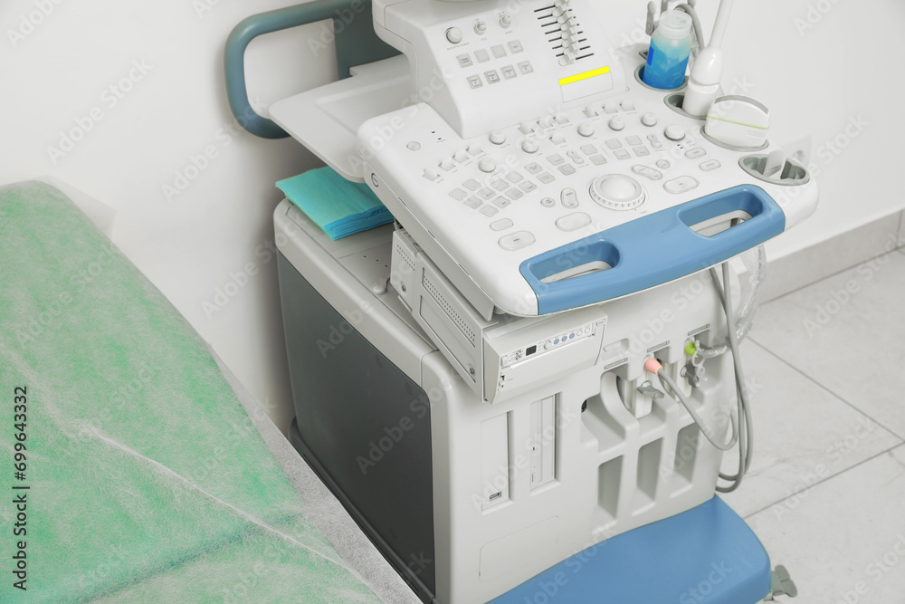 Ultrasound control panel and examination table in hospital, closeup ...