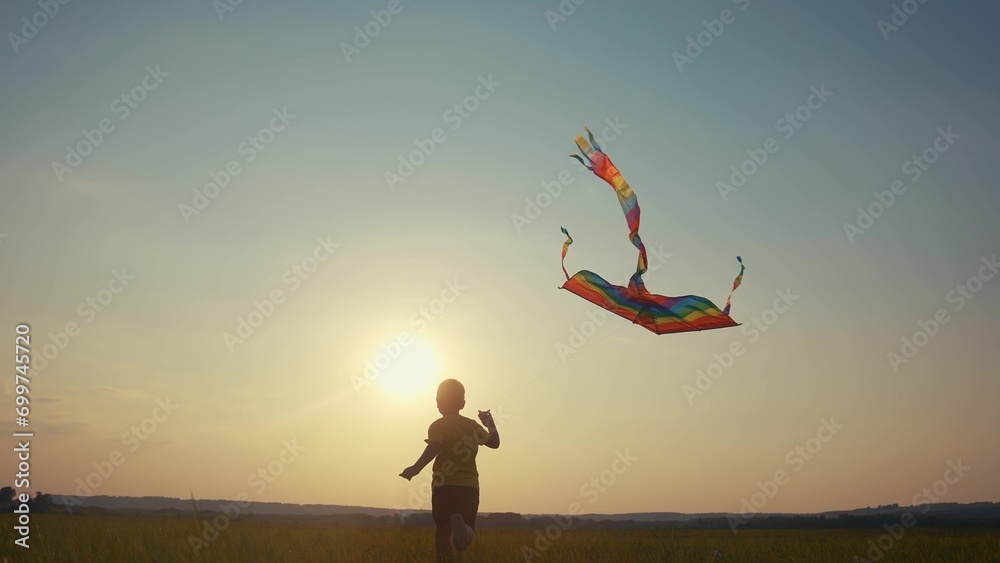 boy running with a kite. happy family kid dream concept. boy son ...
