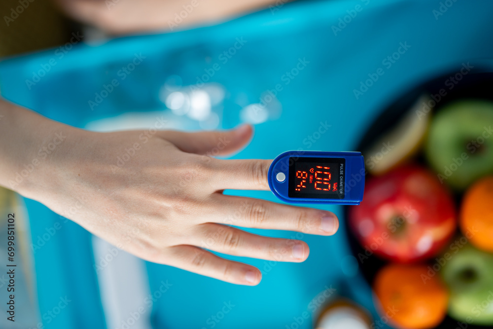 Pulse oximeter attached on finger showing oxygen saturation in blood ...