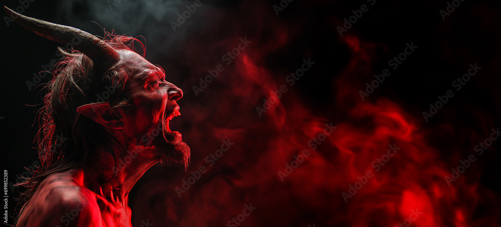 Angry devil profile with copy space for text - black background ...