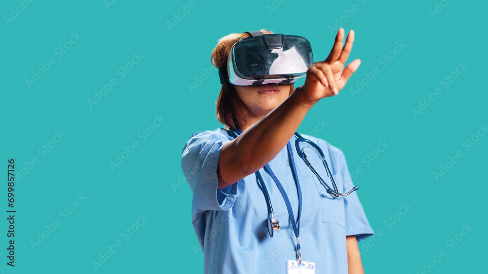 Healthcare professional wearing virtual reality headset remotely ...