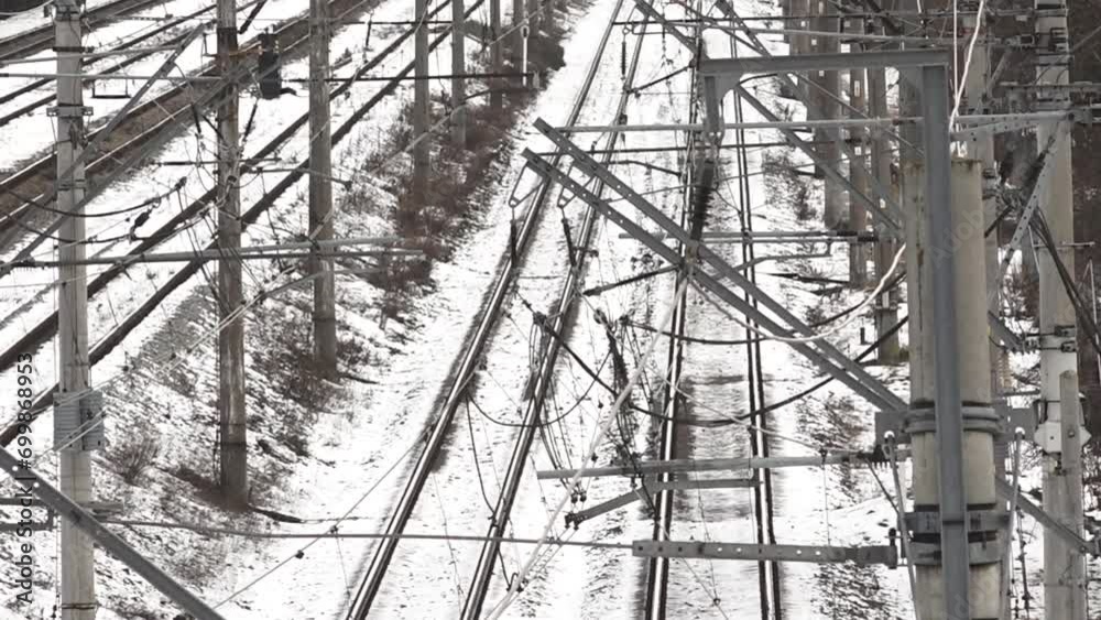 complex network of railway tracks, overhead lines, and signal posts ...