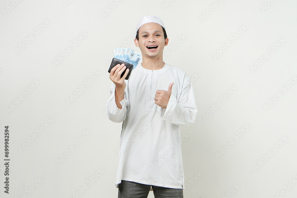 muslim man holding money rupiah banknotes in the wallet and give thumb ...