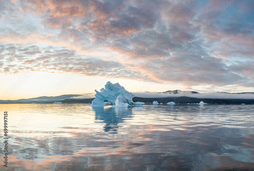 Melting icebergs by the coast of Greenland, on a beautiful summer day ...