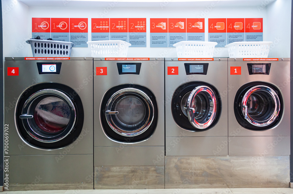 Professional washing machines installed in the city laundry. Stock ...