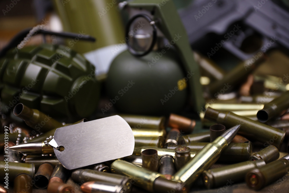 Different types of ammunition and grenades on a camouflage background ...
