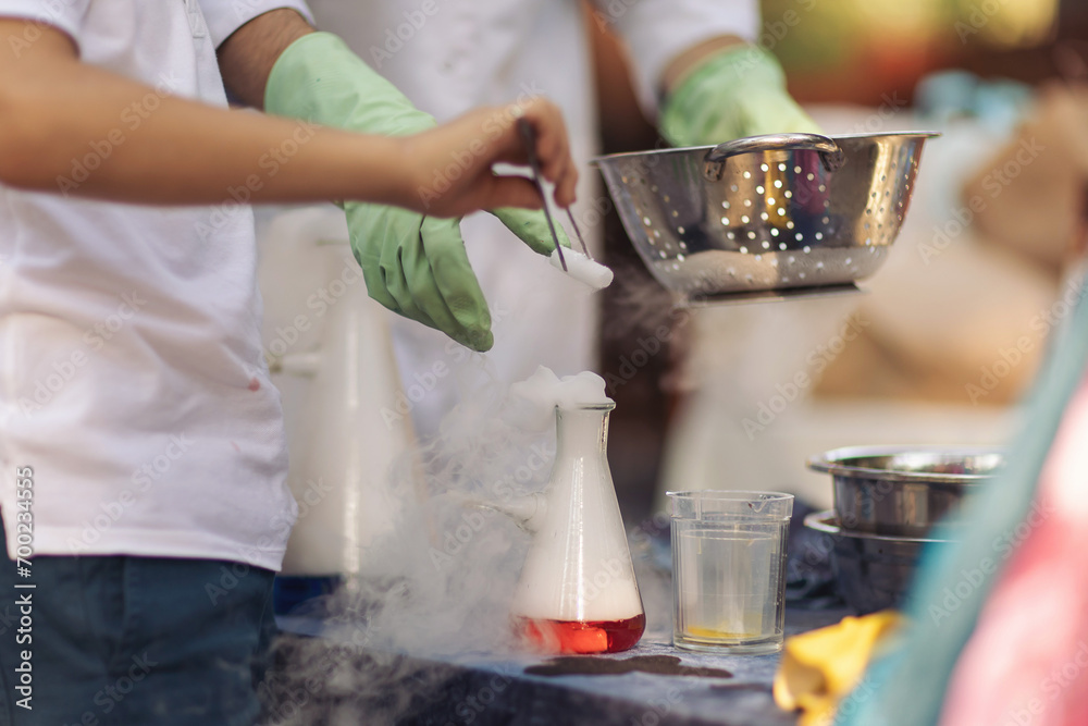 Chemical reaction closeup. Glass flask with puffs of smoke as a result ...