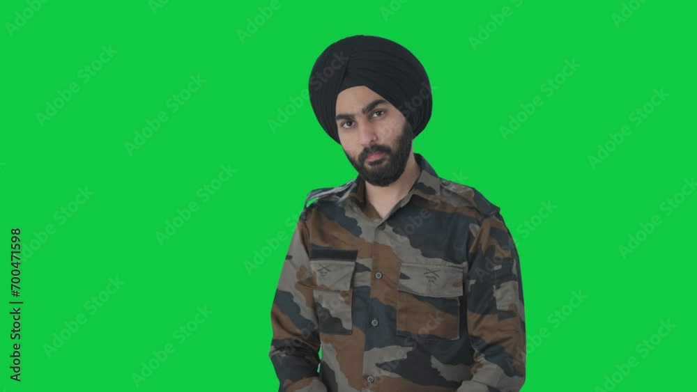 Sikh Indian Army man checking and pointing gun towards enemy Green ...