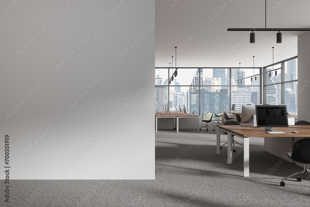 Coworking office interior with desk and pc monitors in row, window ...
