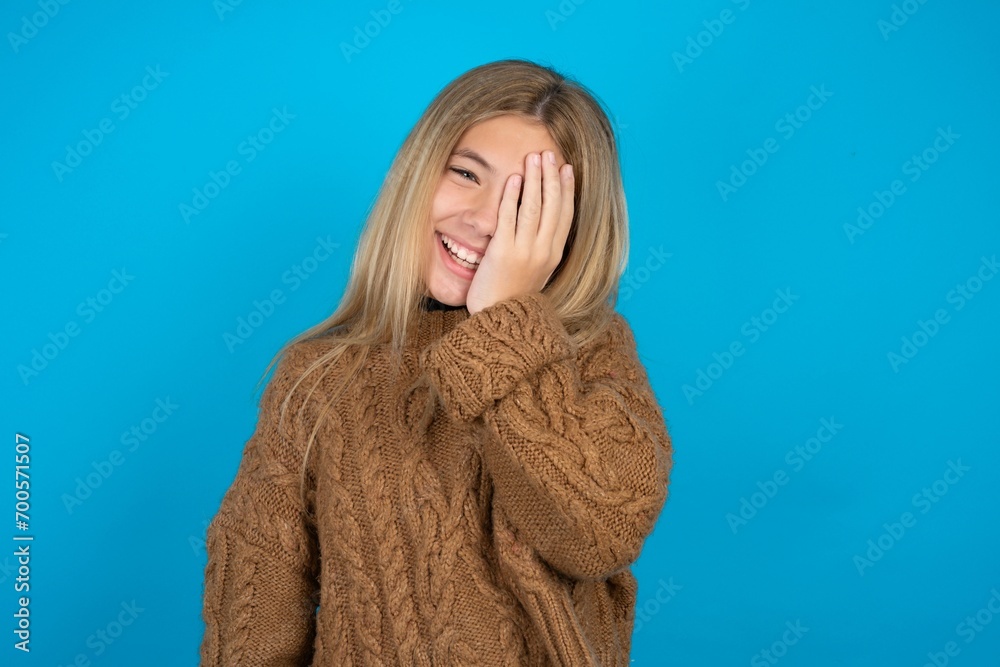 beautiful teen girl makes face palm and smiles broadly, giggles ...