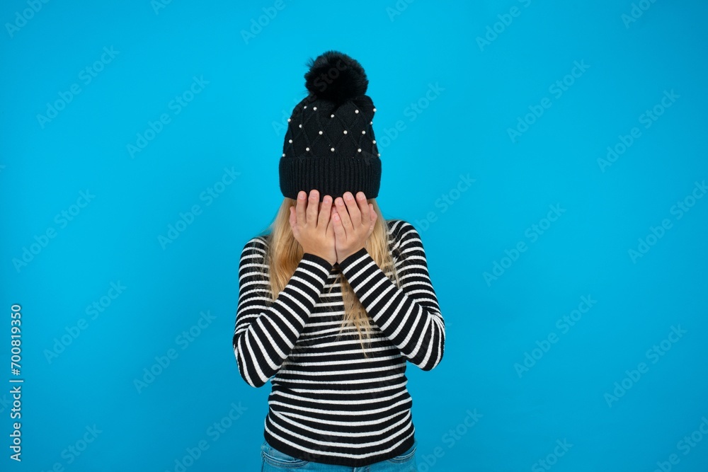 Teen caucasian girl wearing striped sweater and woolly hat covering her ...