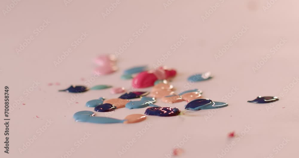 Close-up of Children's hands smearing paint on a sheet of paper is ...