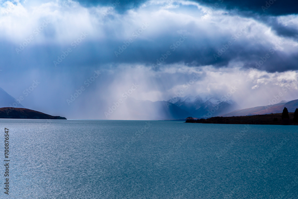 Photograph of early morning sun shining through rain clouds on Lake ...
