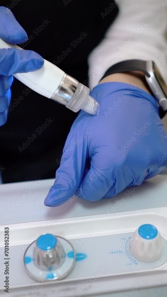 An hair removal master performs a hair removal procedure on a young ...