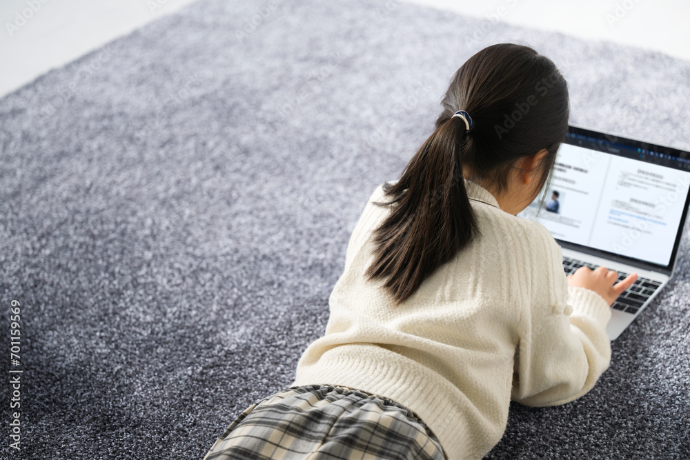 Elementary school students operating a laptop computer to study and do ...