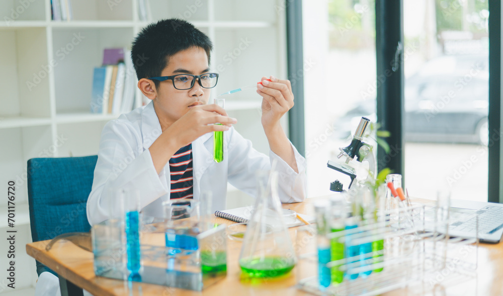 Asian male science students looking through a microscope and tests of ...