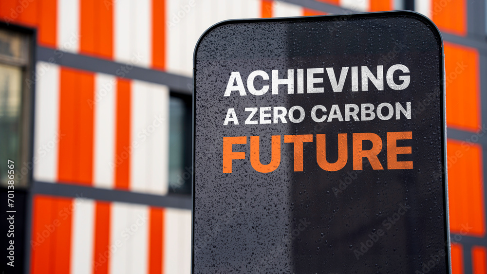 Achieving a zero carbon future on a sign in a city business district Stock Photo | Adobe Stock