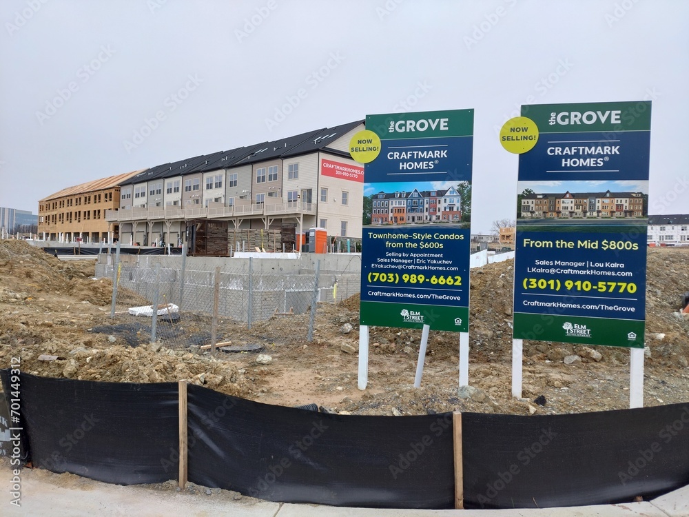 Signs advertise Craftmark Homes in The Grove, a new community in ...