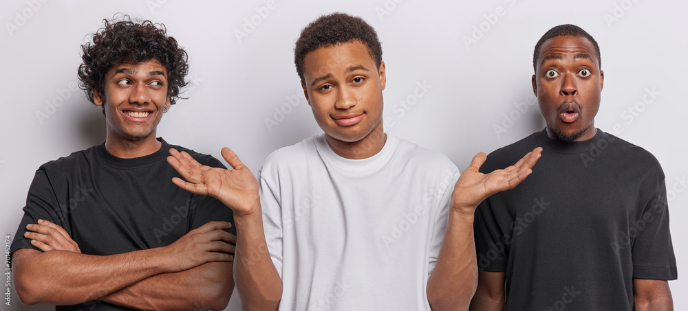 Photo of hesitant Hindu man spreads palms and feels unaware poses ...