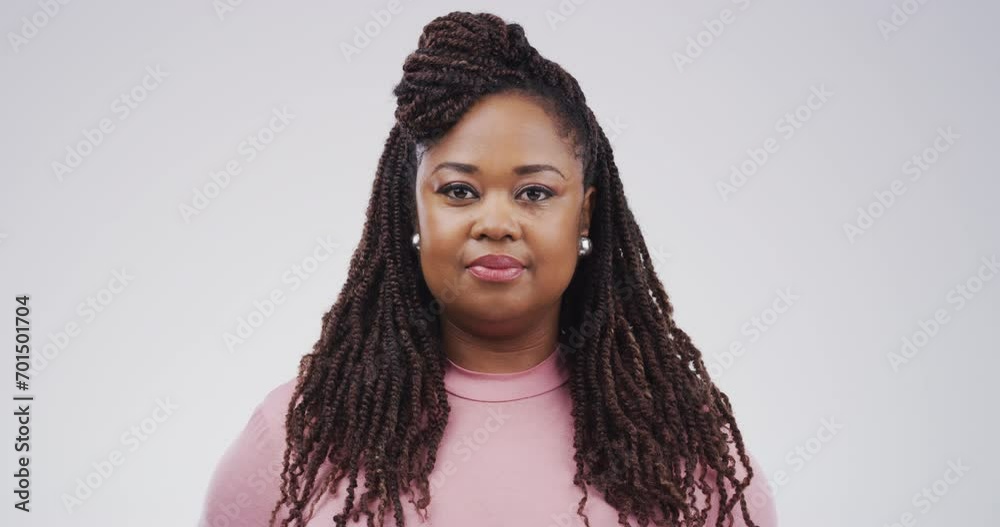 Serious black woman, face and blank stare standing isolated against a ...