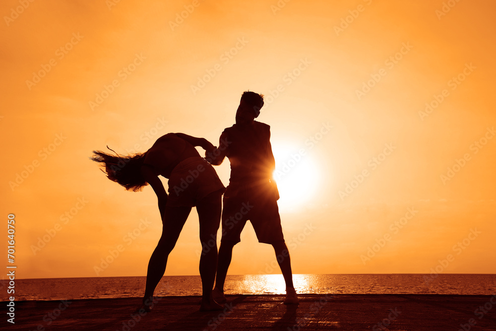 latin hispanic couple is dancing bachata above sea on summer beach ...