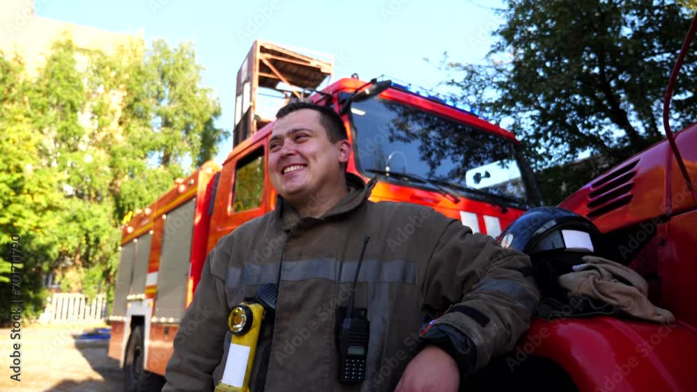 Vidéo Stock Portrait of happy young fireguard in uniform against ...