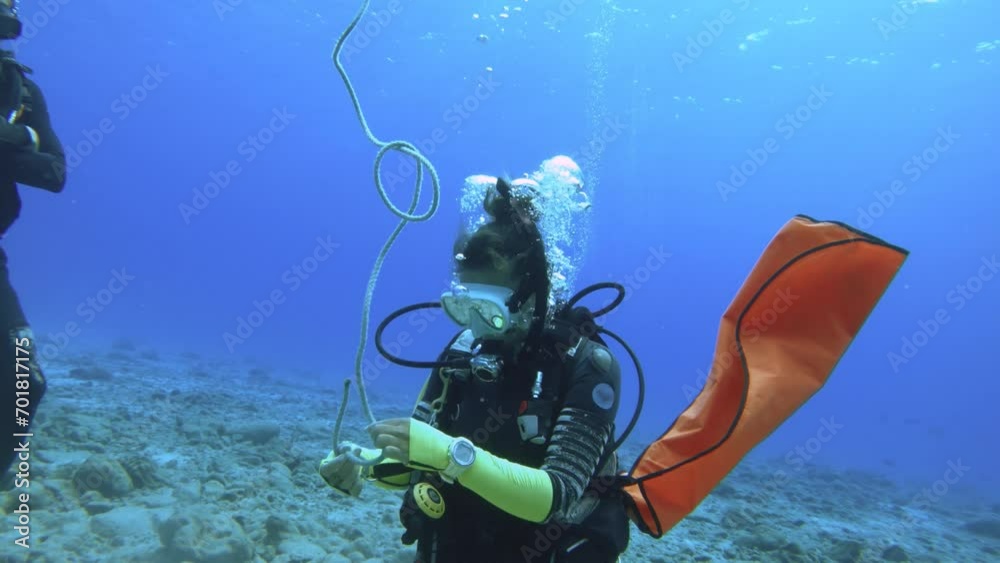 still view of a female woman scuba diving instructor wearing gear ...