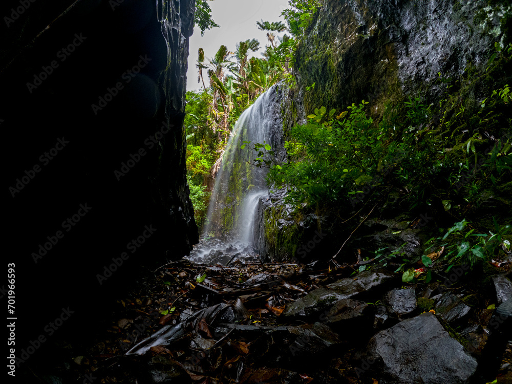 View of a waterfall from a cave hidden in Mauritius island Stock Photo ...