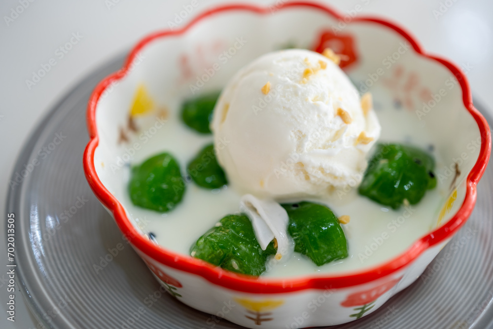Inthanin dessert or Yoksod Pandan Ball in coconut milk with coconut ...