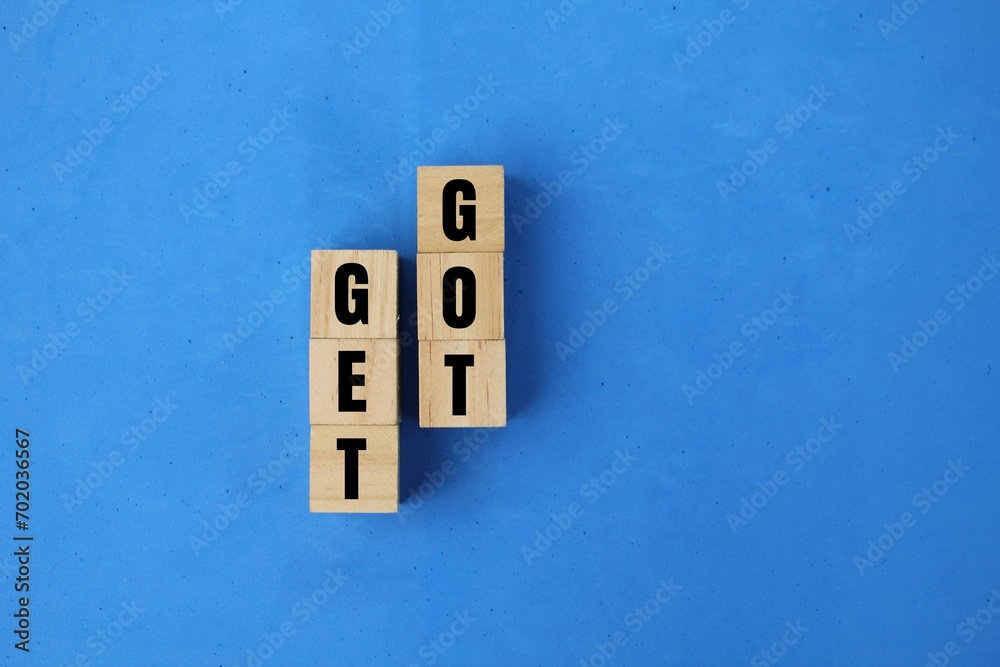 wooden cube with the words got and got. grammar concept. Get is the ...