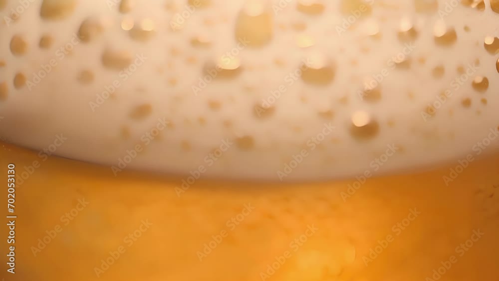 An upclose look at the frothy head of a freshly poured pint of beer ...