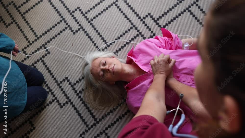 First aid emergency CPR to woman having heart attack - senior woman ...