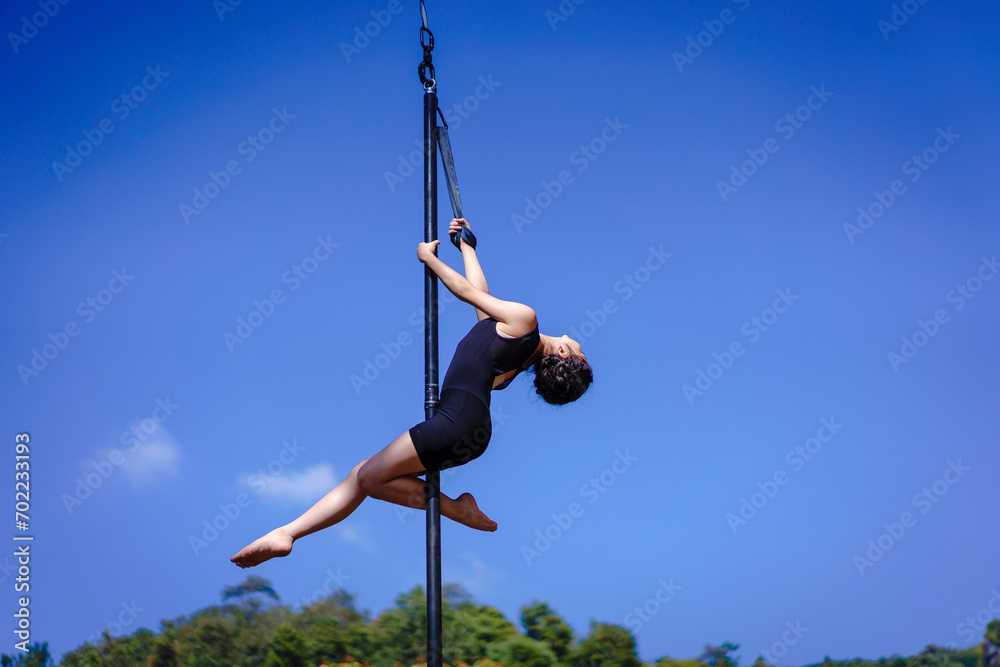 Beautiful Asian girl shows extreme advances by performing pole dance ...
