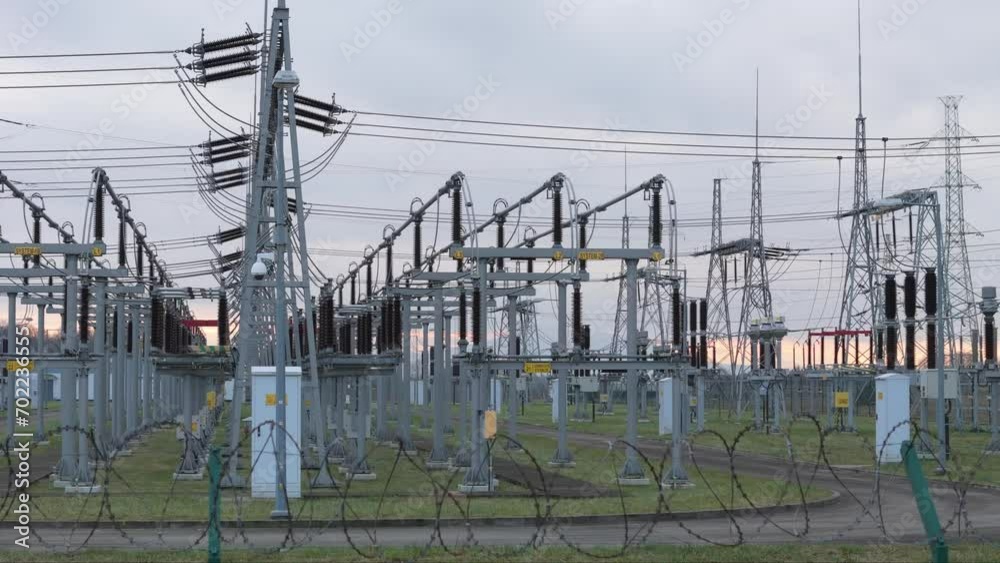 A drone's eye captures the silhouette of a transformer station against ...