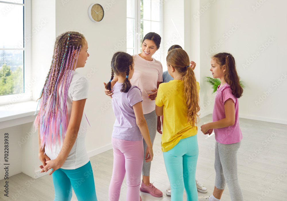 Friendly female choreographer rejoicing the success of her students ...