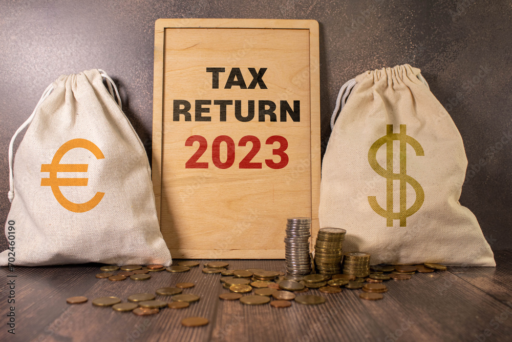 Tax text in wooden cubes and tax or vat form documents to complete ...