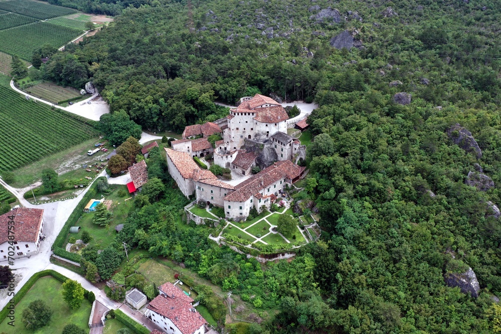 aerial view of Castel Pietra, manor is located on the slope of the hill ...