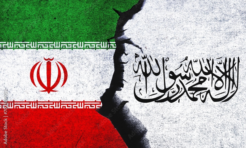 Taliban and Iran flags on wall with a crack. Iran and Taliban conflict ...
