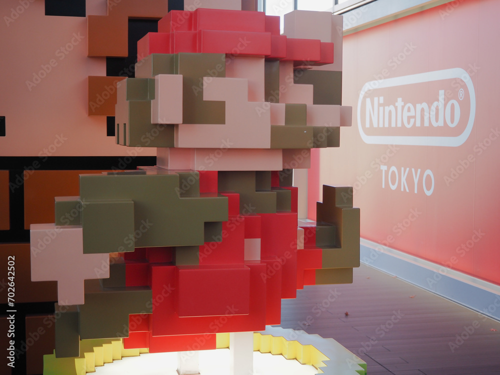 TOKYO, JAPAN - January 4, 2024: A statue of Mario and Nintendo sign ...