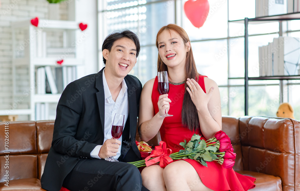 Asian male boyfriend in formal suit sitting smiling hold tall wine ...