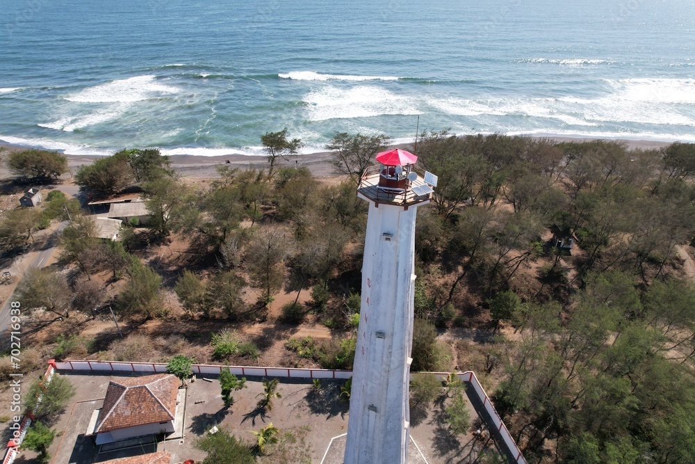 aerial view of white-walled lighthouse. A lighthouse is a tower ...