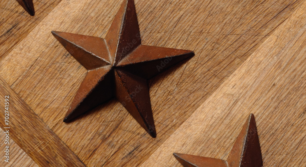 Cast iron 5 point star on a distressed oak plank Stock Photo | Adobe Stock