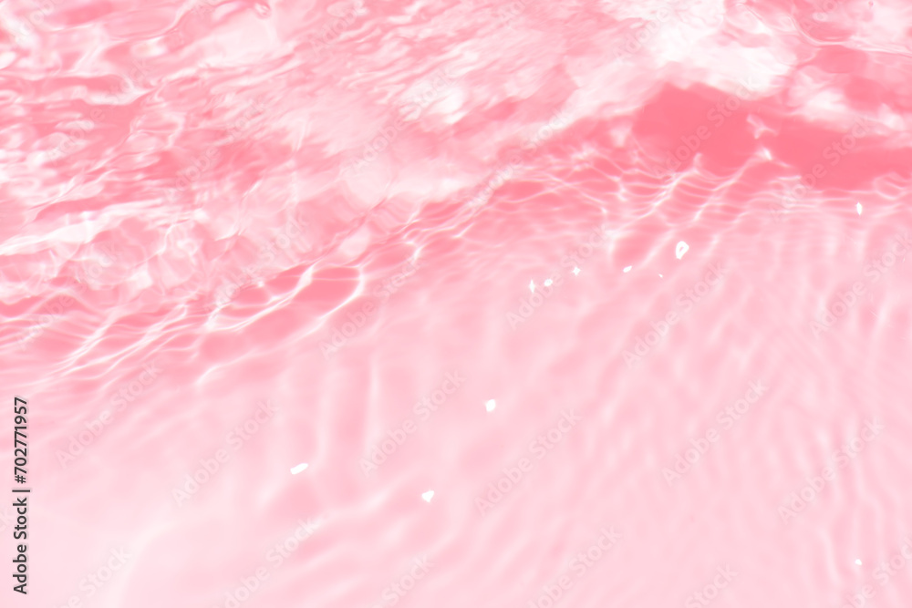 Pink water splashes on the surface ripple blur. Defocus blurred ...