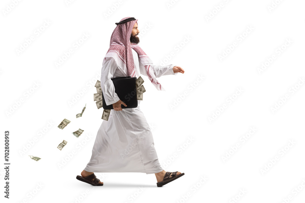 Full length profile shot of a suadi arab man walking with a briefcase ...