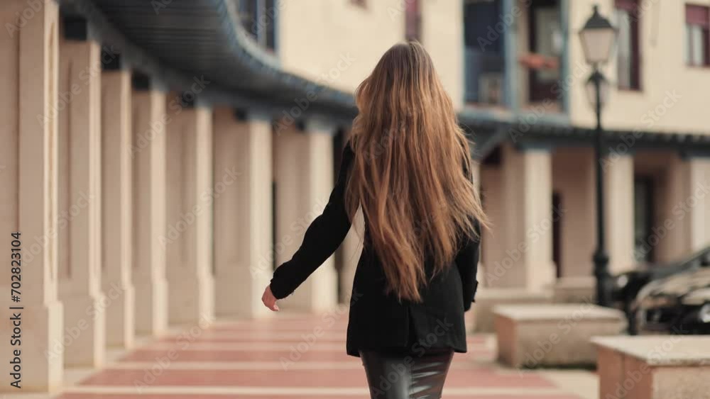 Confident walk of a strong woman, student. The stylish lady walks ...